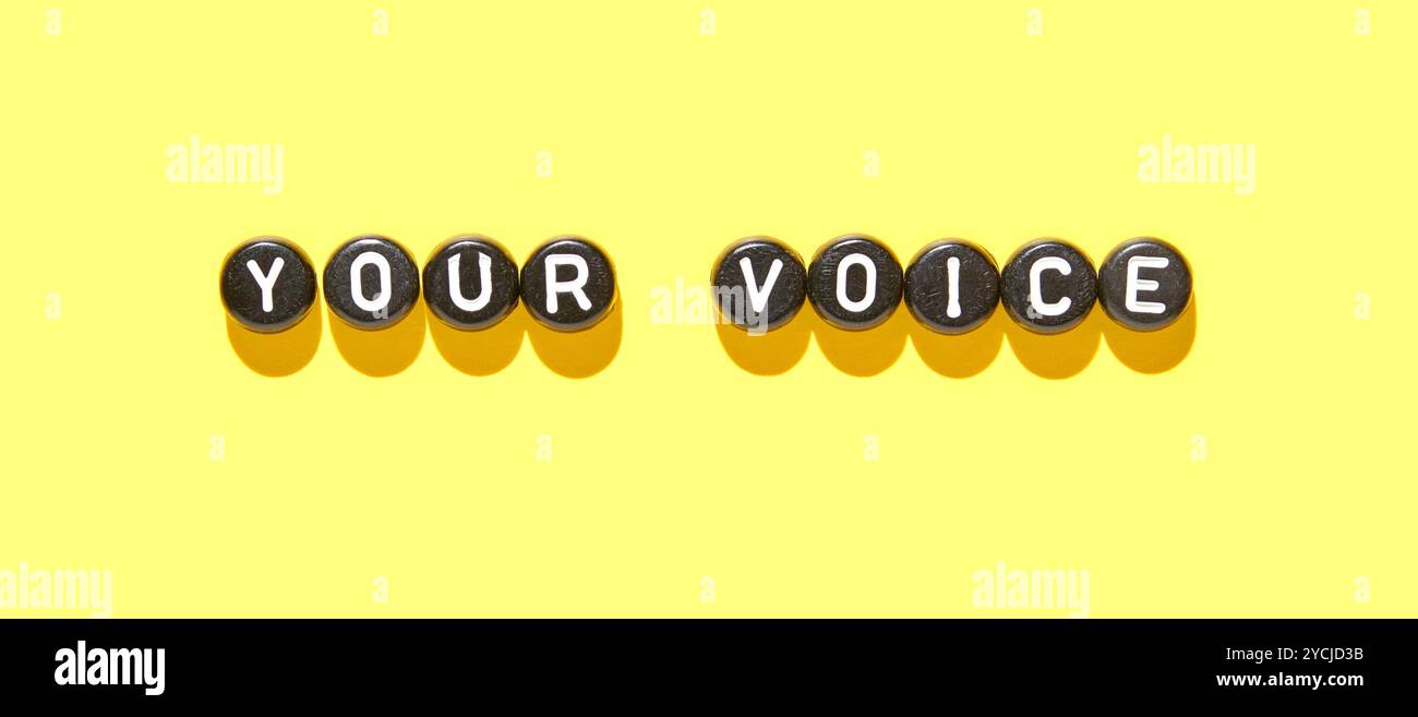 Your voice concept with letter beads on bright yellow background for ...