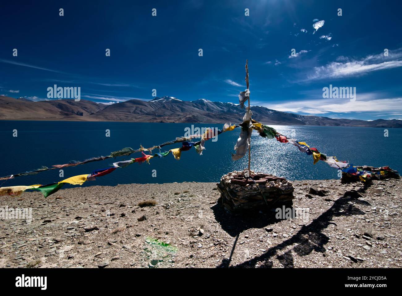 View at Tso Moriri Lake, Stone pyramid and Buddhist praying flags ...