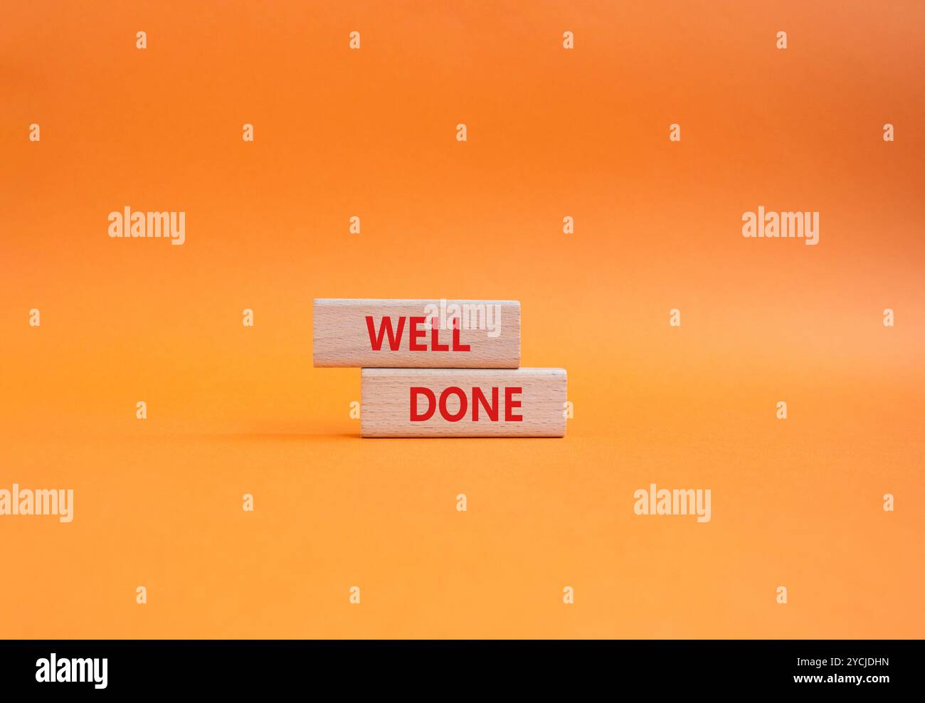 Well done symbol. Wooden blocks with words Well done. Beautiful orange ...