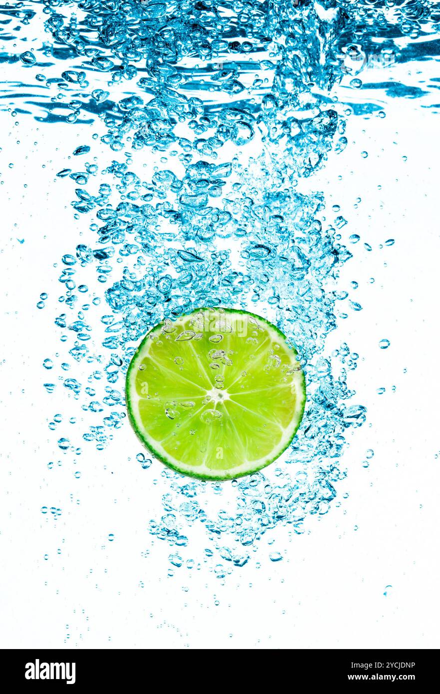 Fresh green lime in the clear water on white background Stock Photo - Alamy