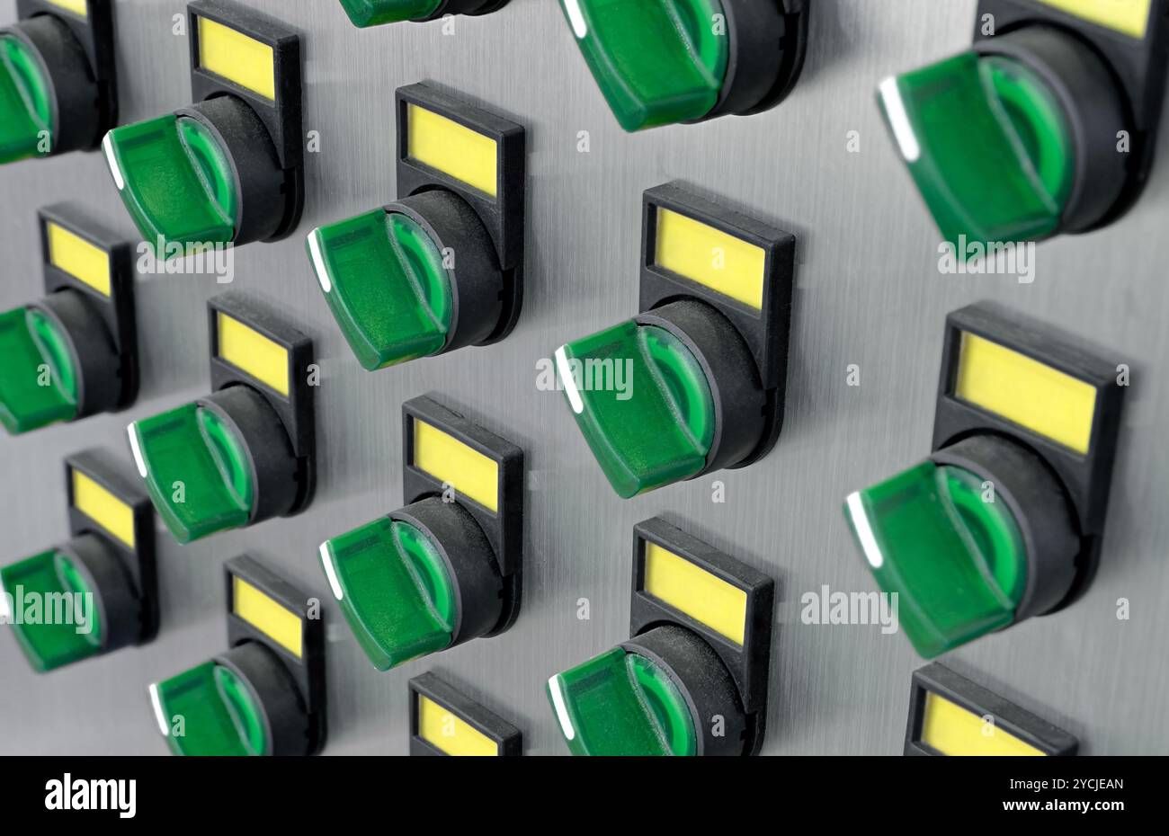 A lot of green electric switches with yellow labels on a brushed metal ...