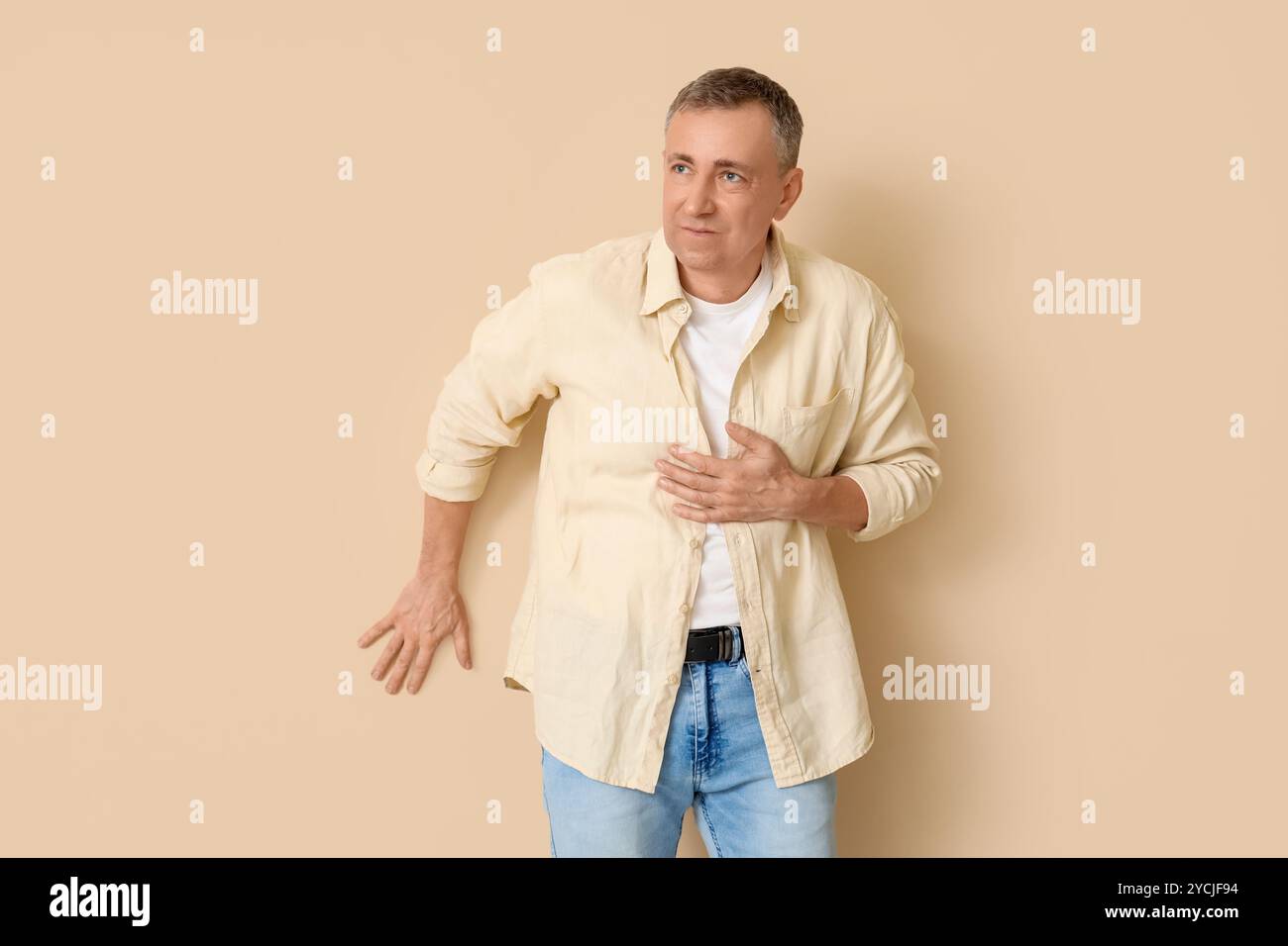 Mature man chest pain middle aged hi-res stock photography and images ...