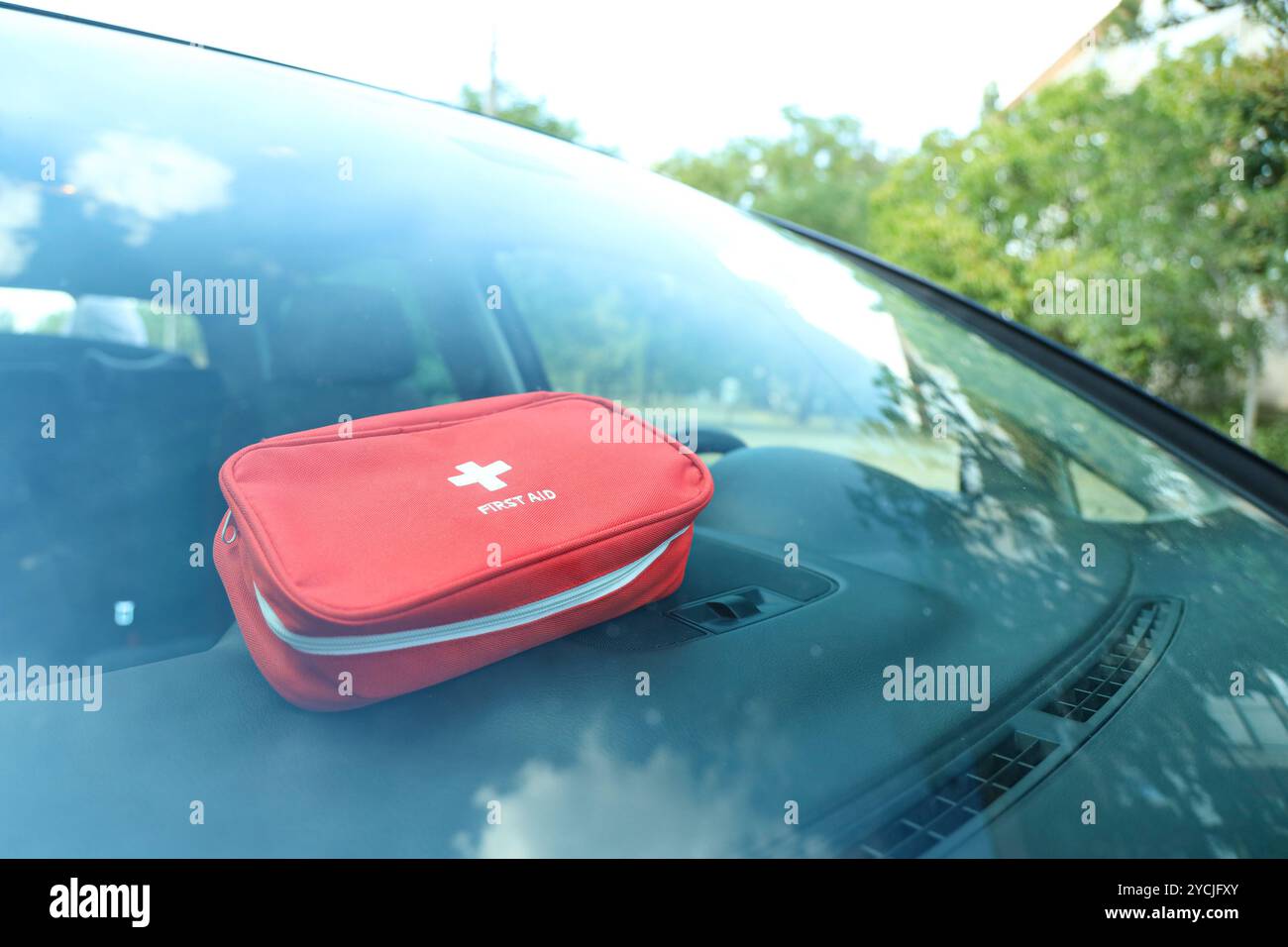 First aid kit on car dashboard, view through windshield Stock Photo - Alamy