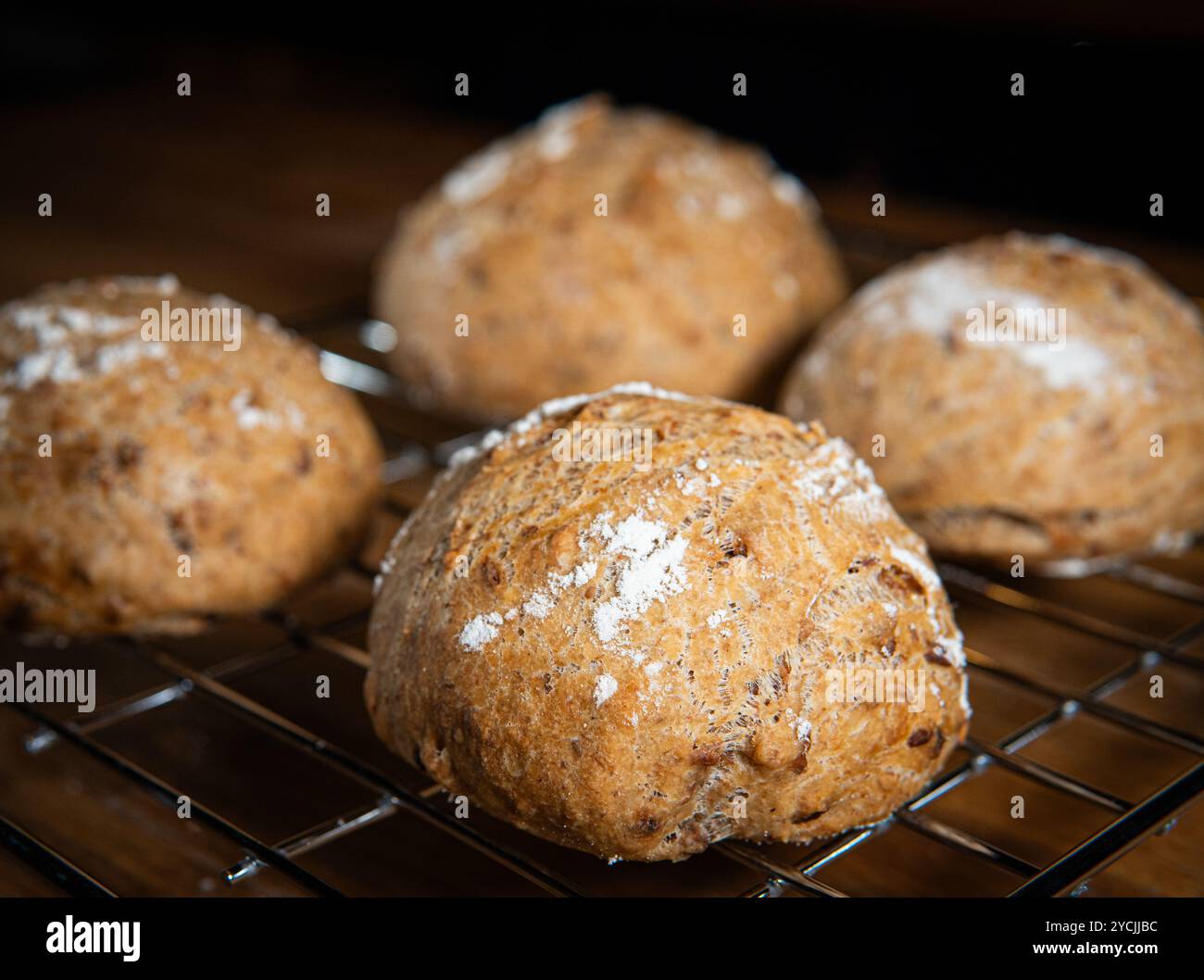 Four classic farm country bread buns on a grill. These homemade rustic ...