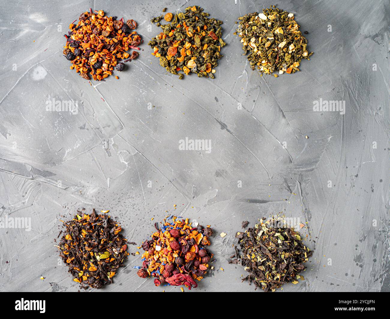 Assorted dry tea of different varieties with additives on a gray ...