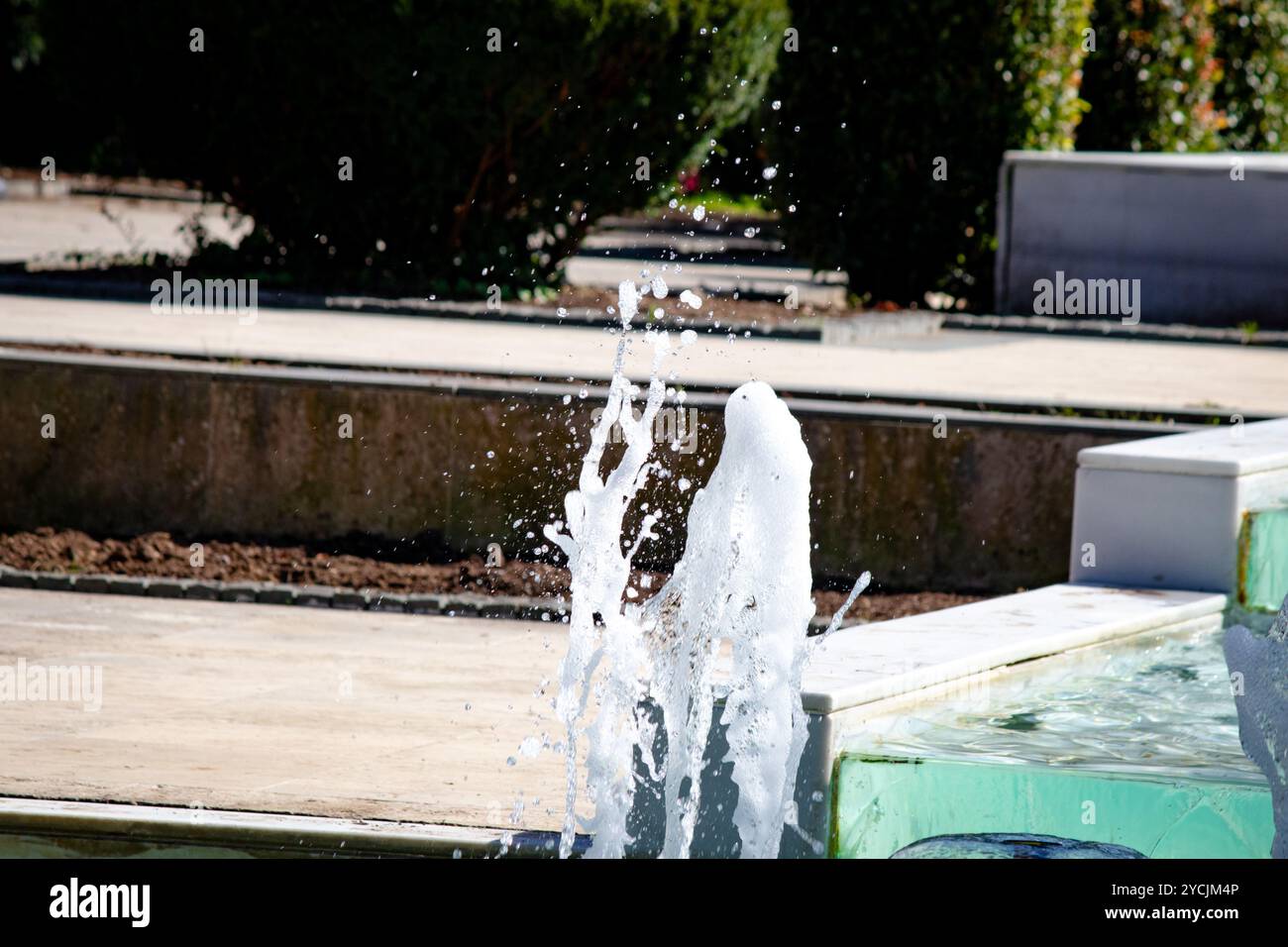 Gushing water in the ornamental pool. Horizontal photo. No people ...