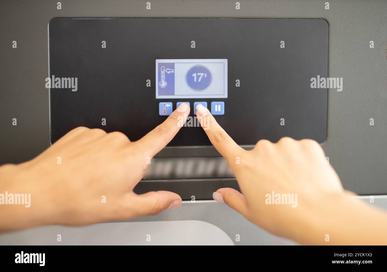 Adjusting temperature settings on a modern appliance display in a ...