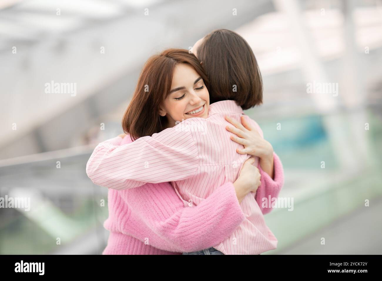 Two smiling women embrace warmly hi-res stock photography and images ...
