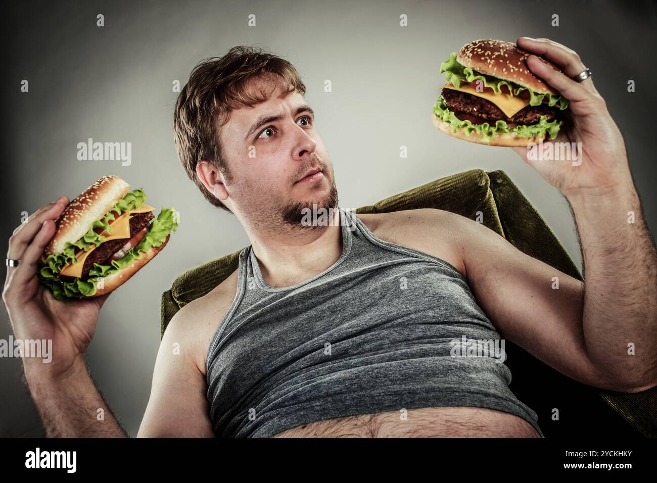 Fat man eating hamburger Stock Photo - Alamy