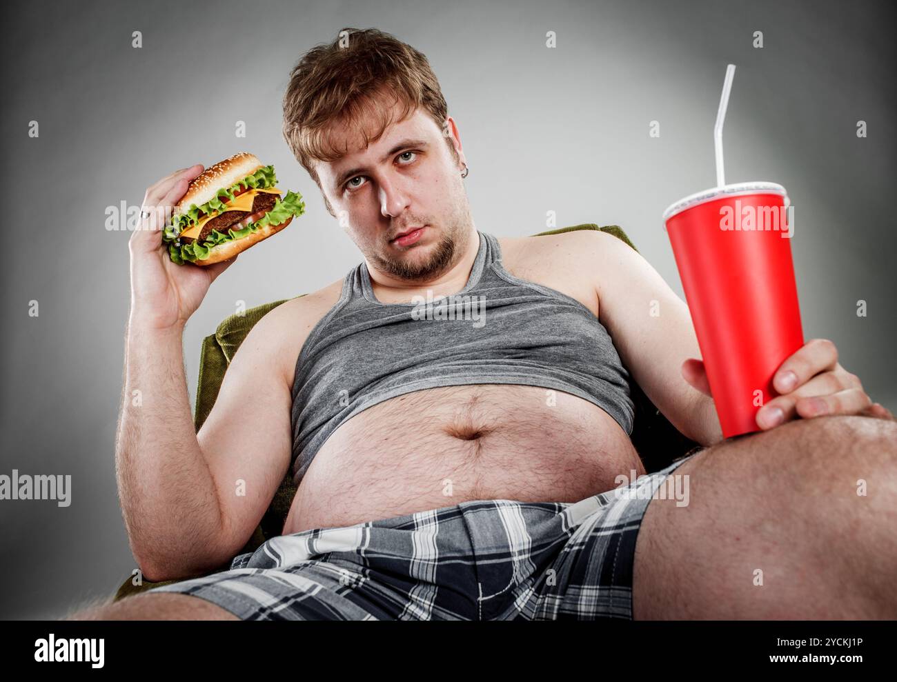 Fat man eating hamburger Stock Photo - Alamy