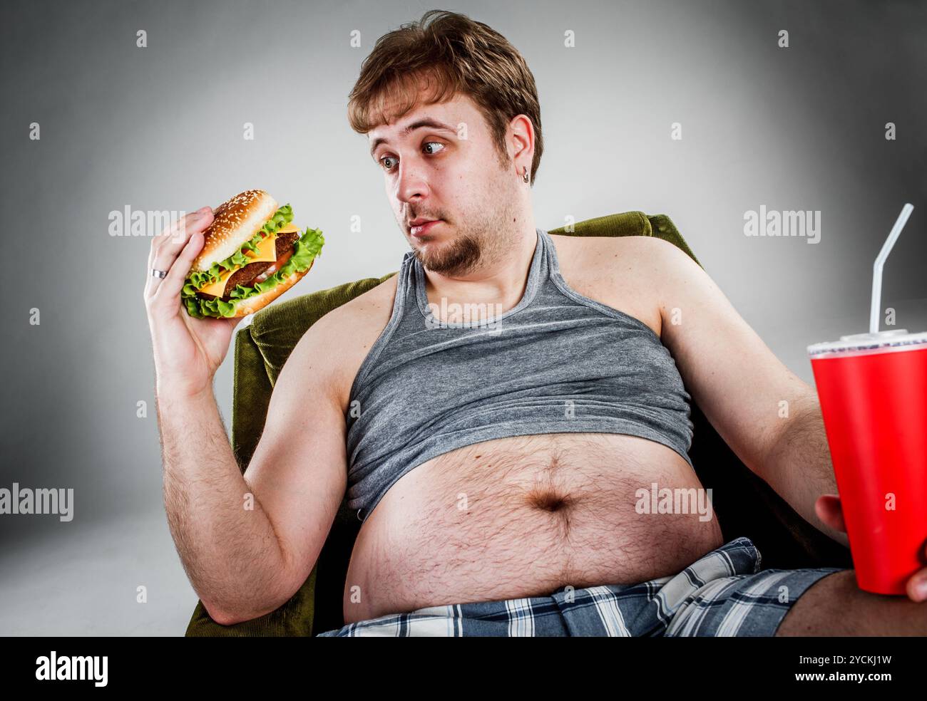 Fat man eating hamburger Stock Photo - Alamy