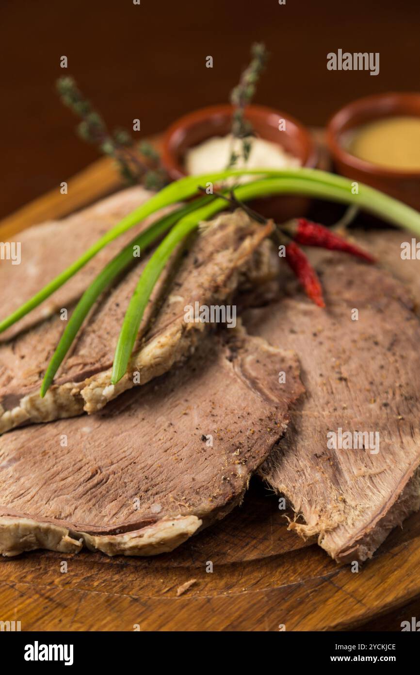 Sliced boiled meat presentation on wood board Stock Photo - Alamy