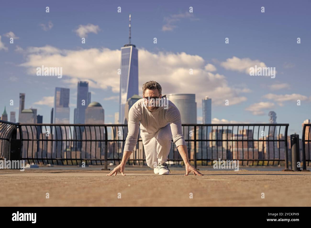 Sprinter leaving starting on running track outdoor. Runner on start ...