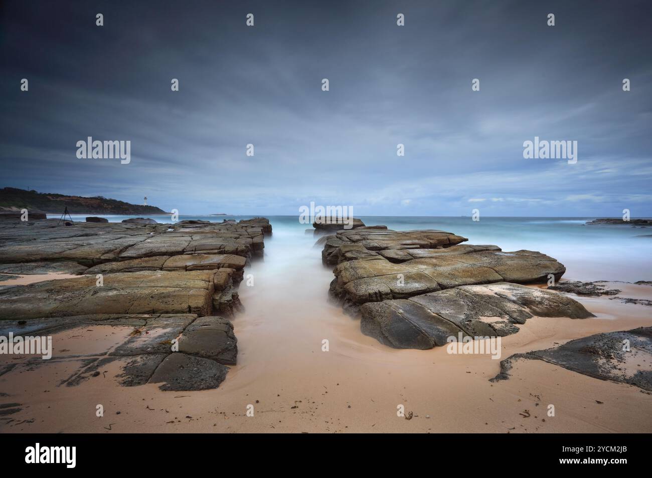 Stormy beach with natural rock channel Soldiers Beach point Stock Photo ...