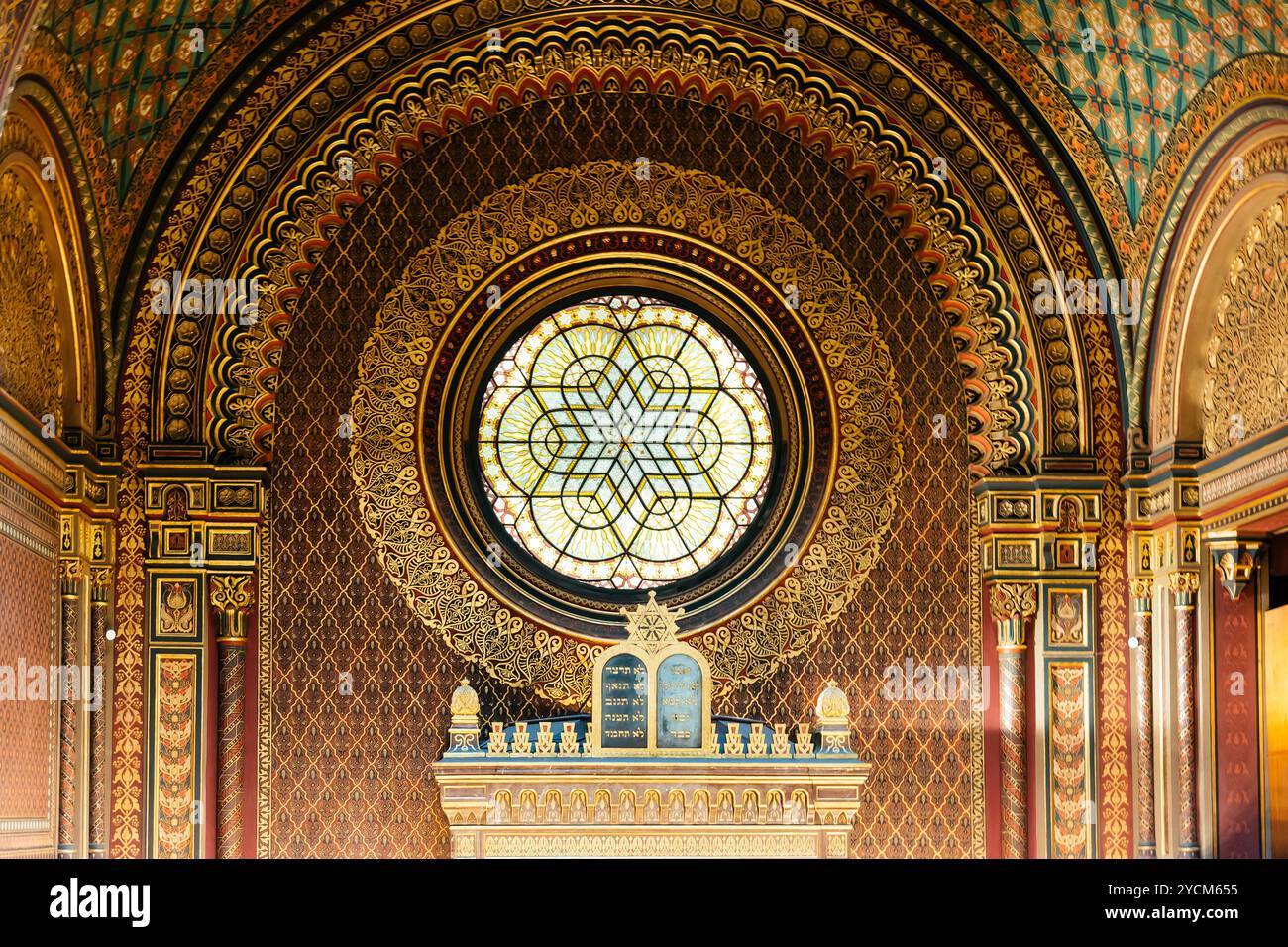 Eastern wall there is a great round stained glass window with a central ...