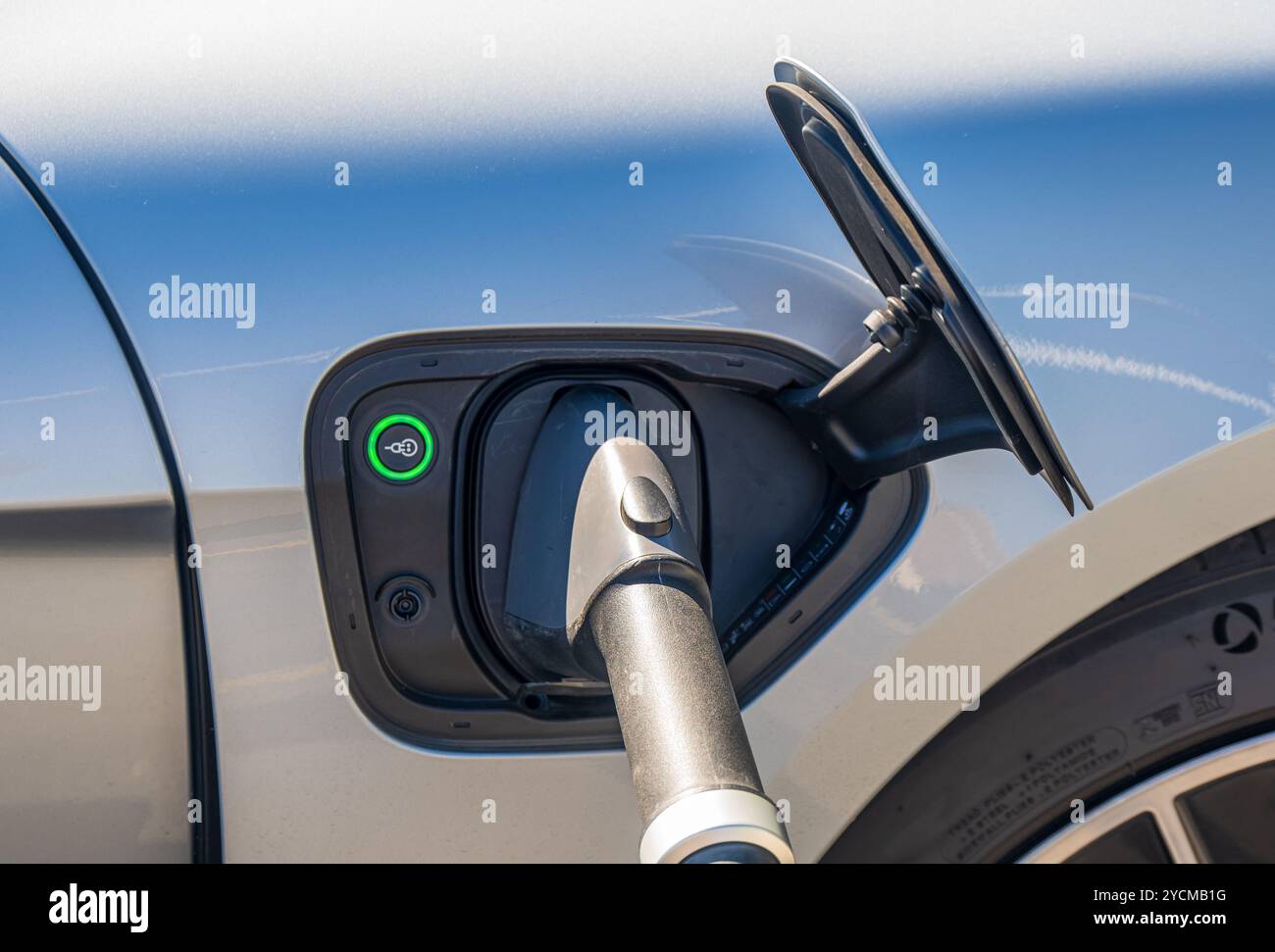 Electric vehicle with charging plug connected Stock Photo - Alamy