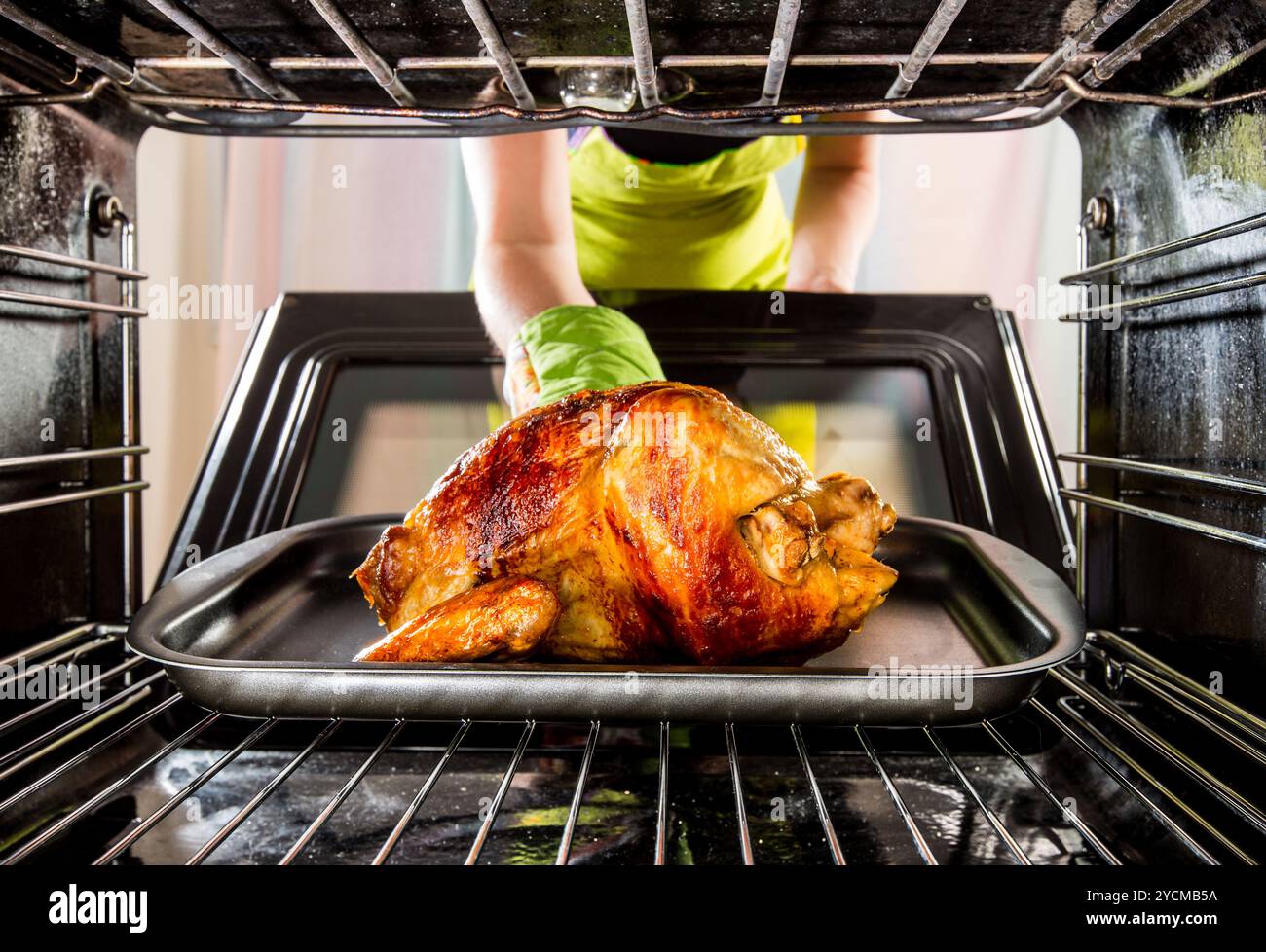 Woman cooking roast chicken in hi-res stock photography and images - Alamy