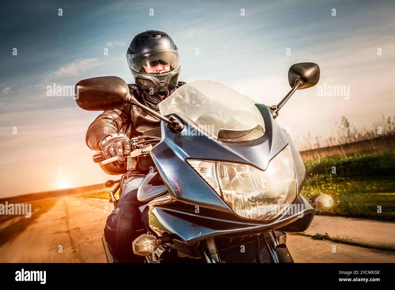 Biker racing on the road Stock Photo - Alamy