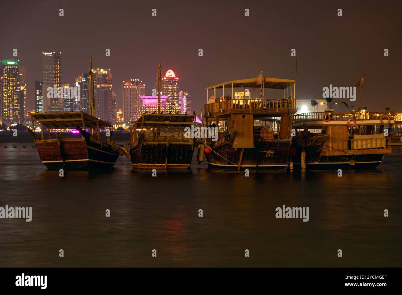Traditional boats called Dhows are anchored in the port near Museum of ...