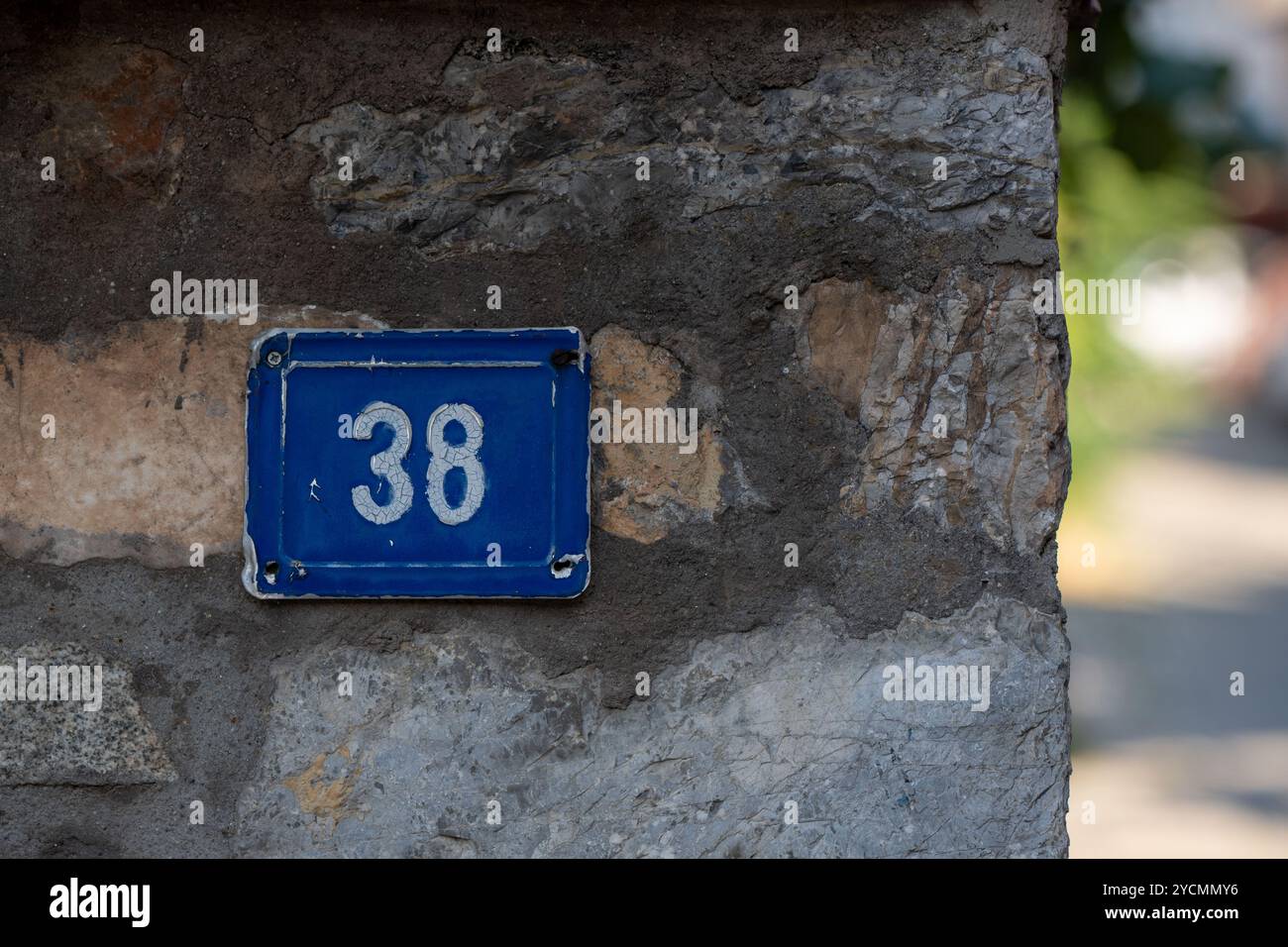 Number 38 in Blue: White Numerals on Metal Plate Around the Blurry ...