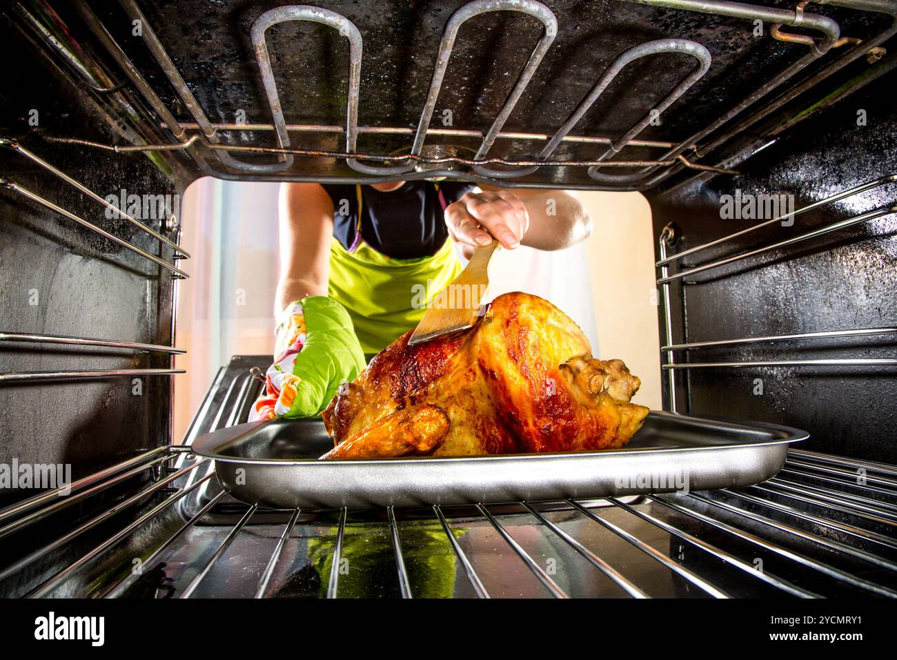 Woman cooking grill oven hi-res stock photography and images - Alamy