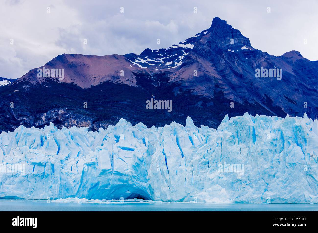 Galcier icebergs floating in the lake. Blue ice walls of the huge ...