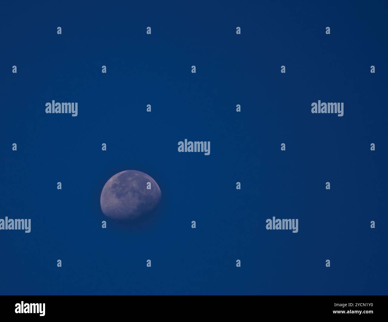 Photograph of a grey colored Moon in a blue sky, photographed in ...
