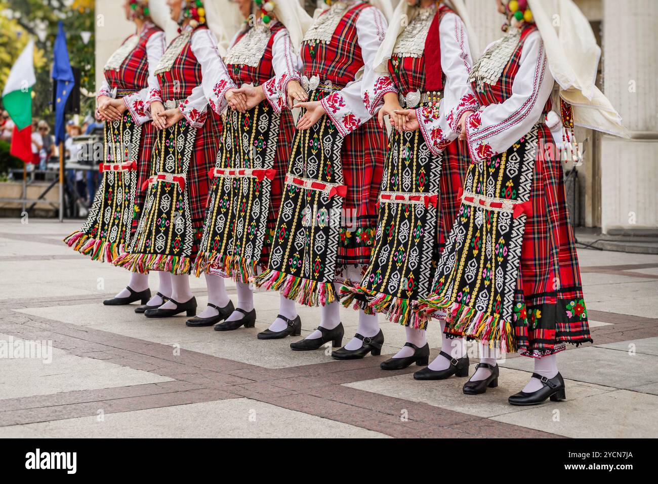 Women dressed in colorful traditional folk costumes dancing in cultural ...