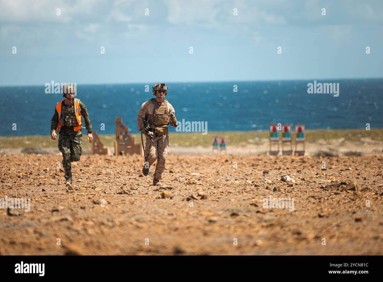 A Dutch Marine, left, with Marine Squadron Carib, runs alongside U.S ...