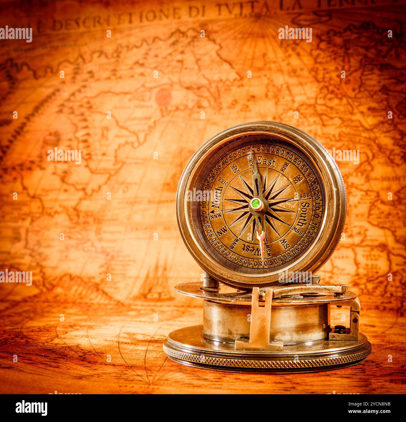 Vintage compass lies on an ancient world map Stock Photo - Alamy