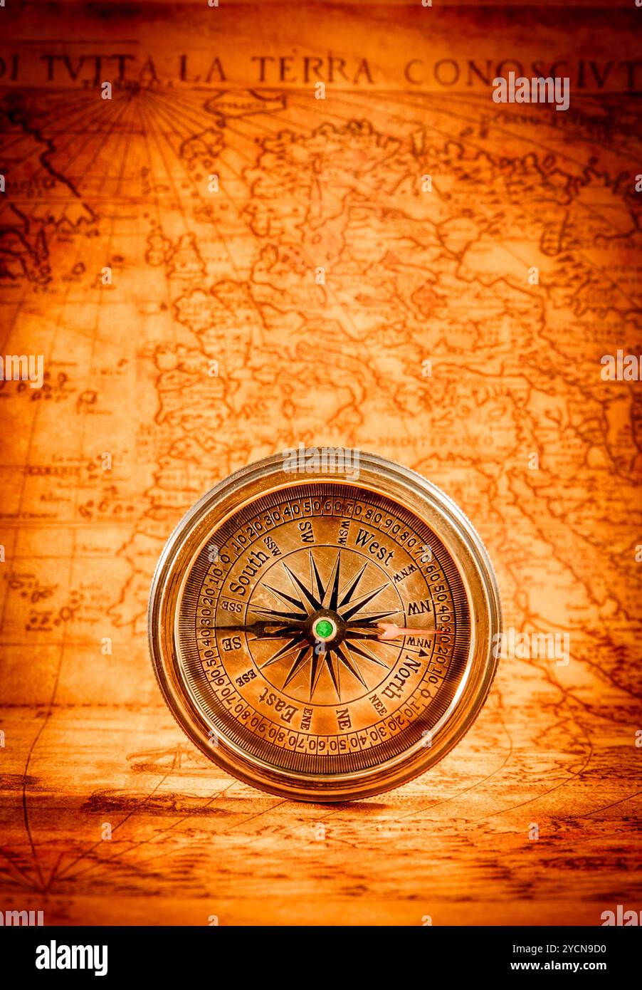 Vintage compass lies on an ancient world map Stock Photo - Alamy