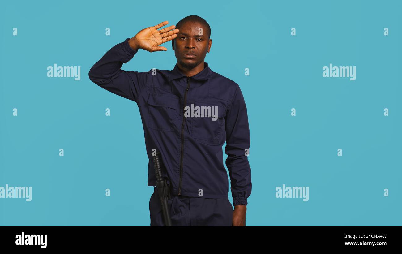 Security guard doing salute hand gesture, preparing to start job of ...