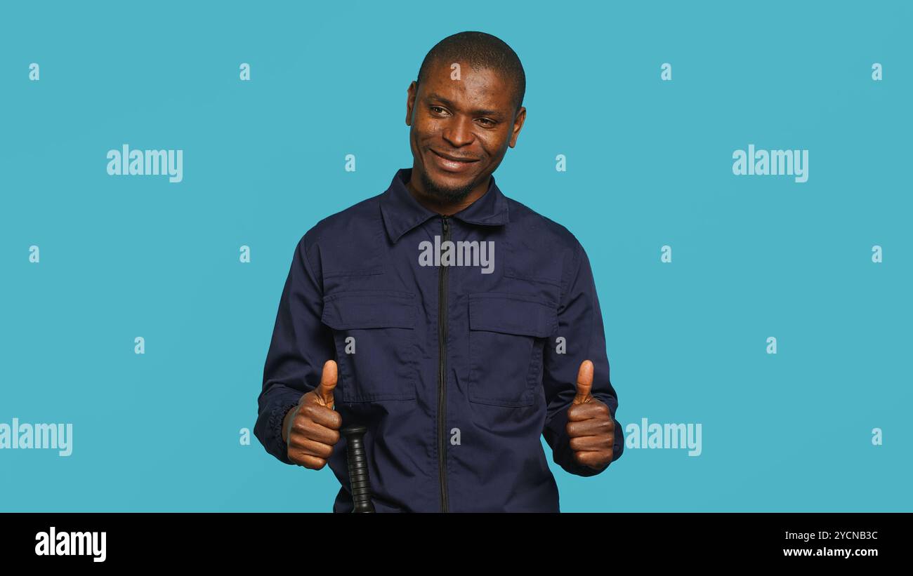 Happy security guard doing thumbs up sign gesturing with finger ...