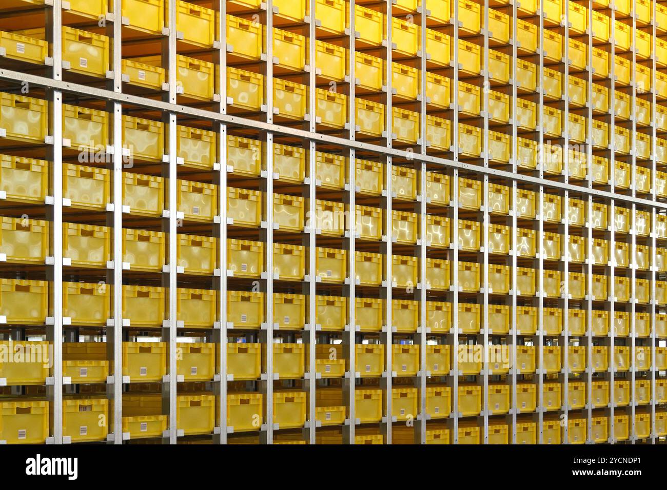 Yellow plastic crates in distribution warehouse Stock Photo - Alamy