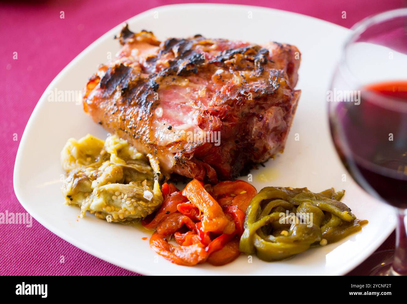Broiled pork knuckle with vegetable garnish Stock Photo - Alamy