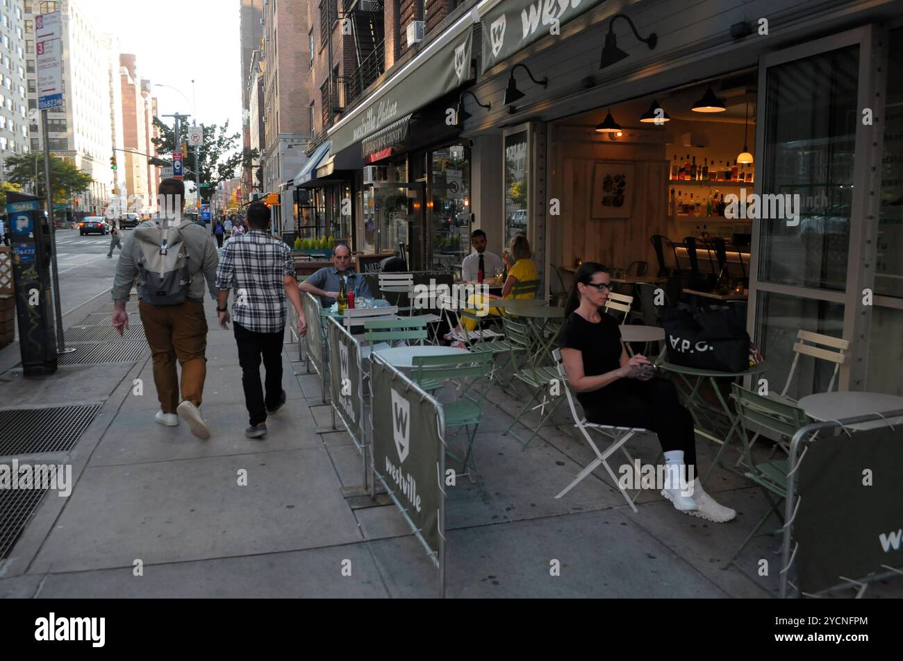 People sit outside of a restaurant in Manhattan, New York City Stock ...