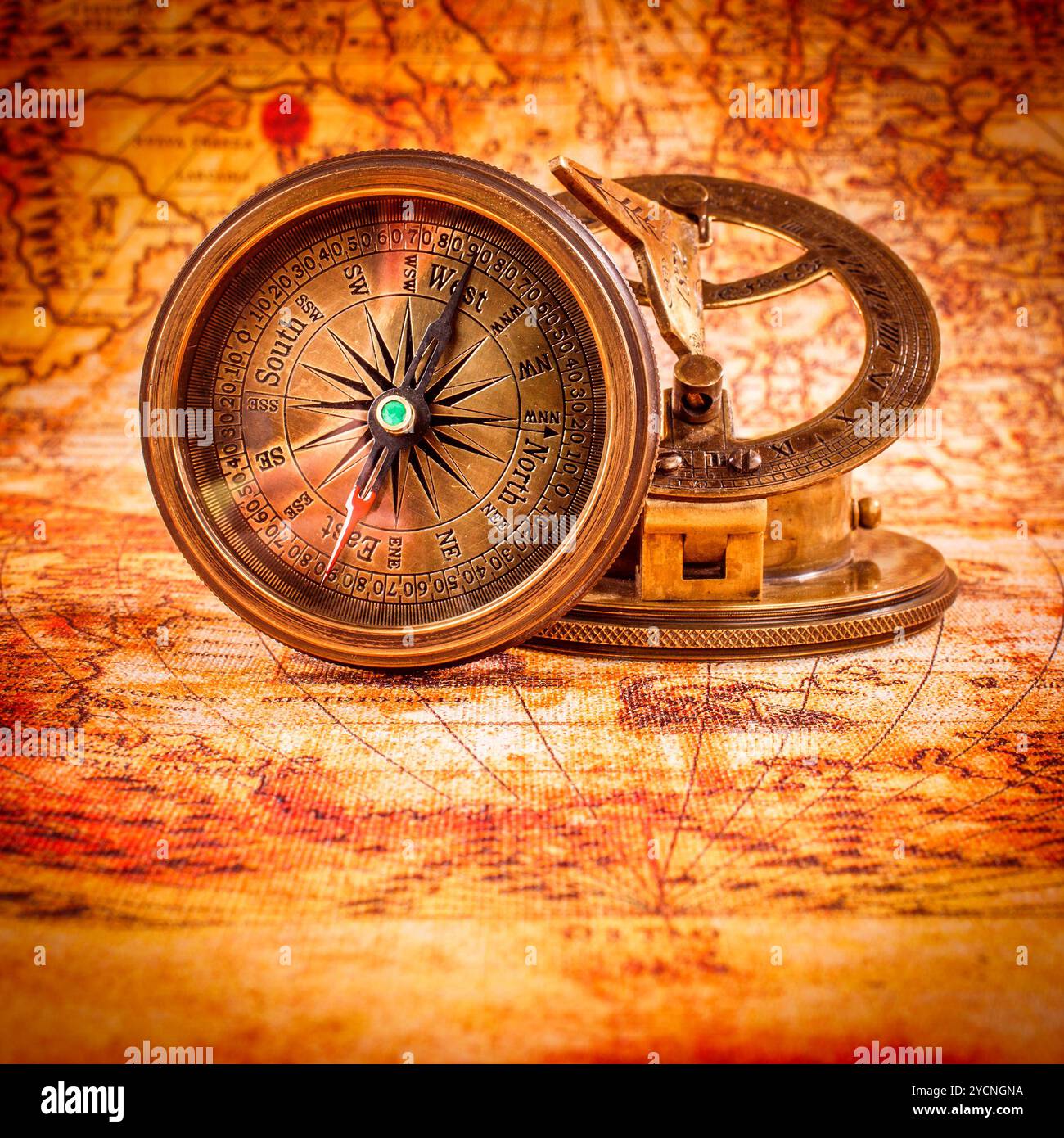 Vintage compass lies on an ancient world map Stock Photo - Alamy