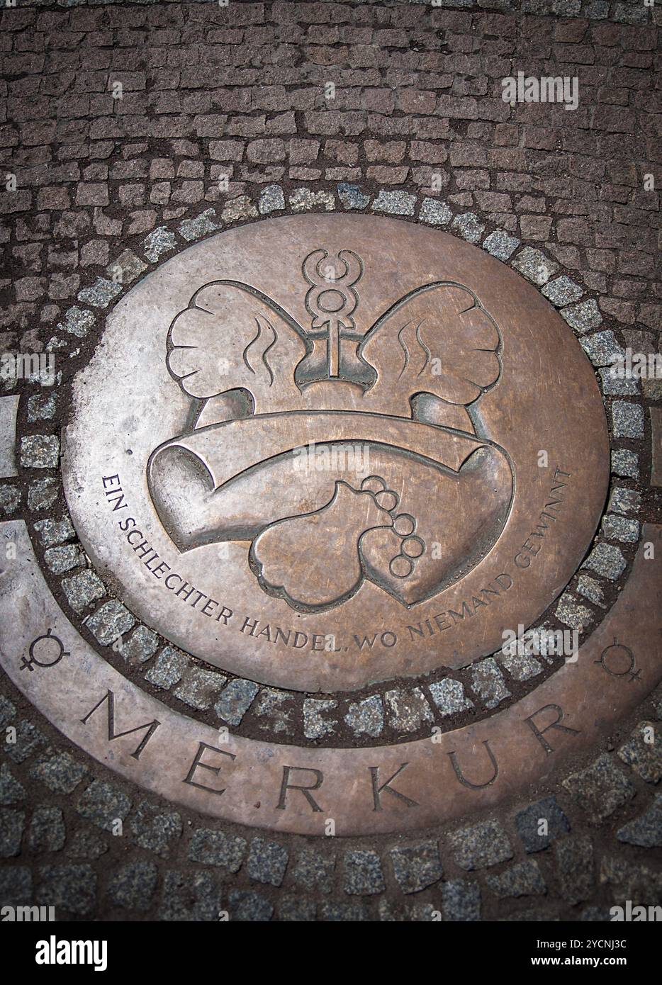 Round Iron hatch for sewer on cobblestone pavement Stock Photo - Alamy