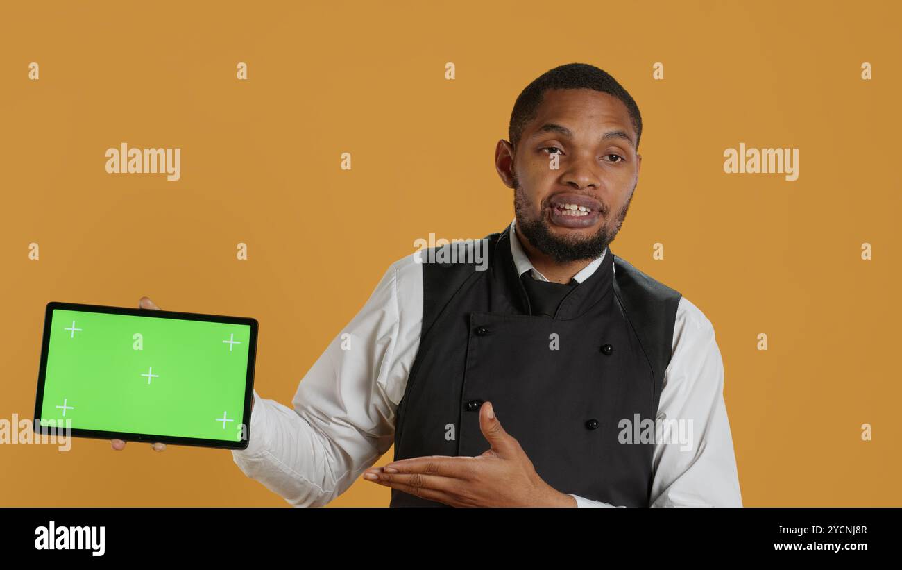 Catering employee presenting an isolated chroma key display while he ...