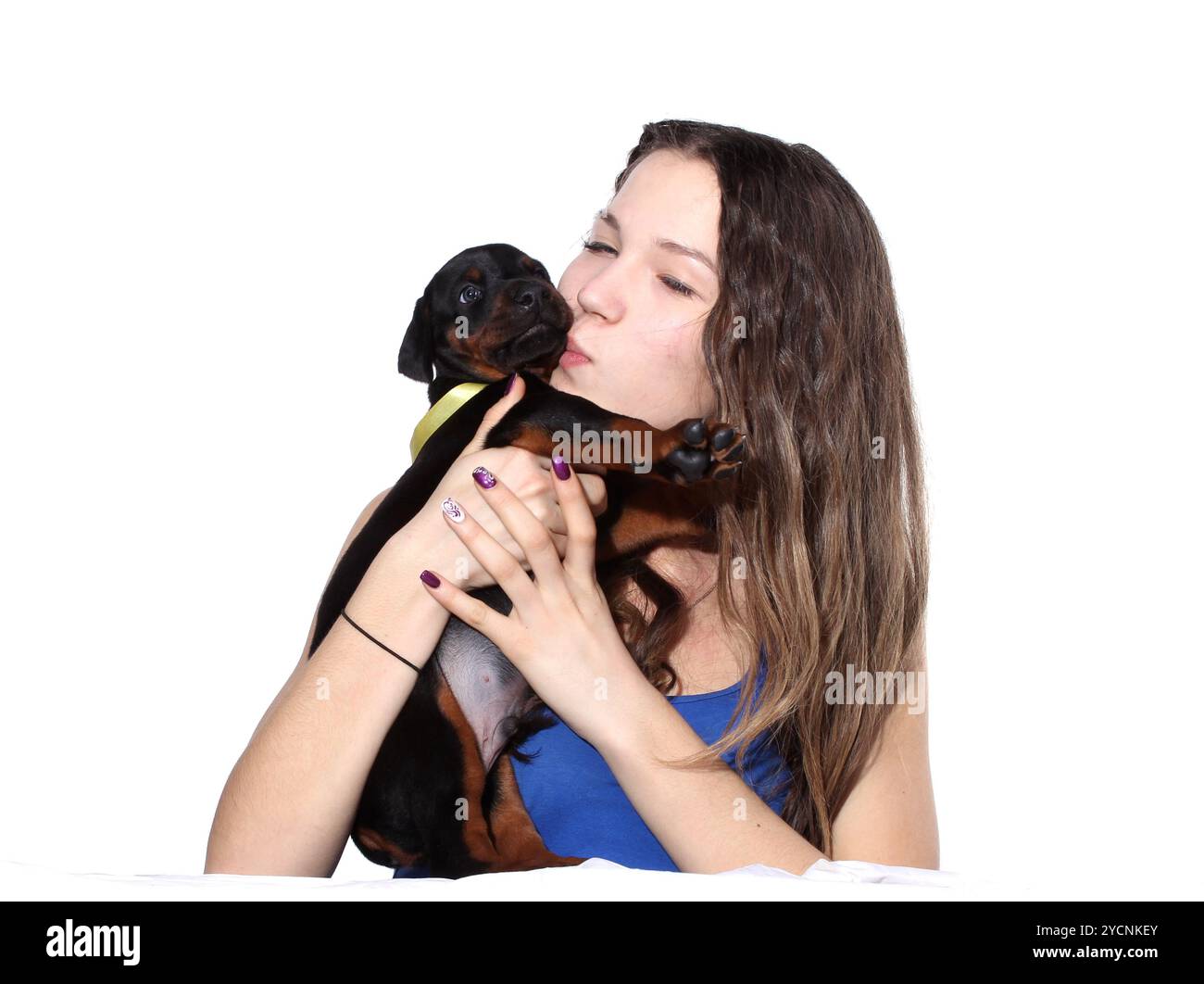 Girl kissing her doberman puppy Stock Photo - Alamy