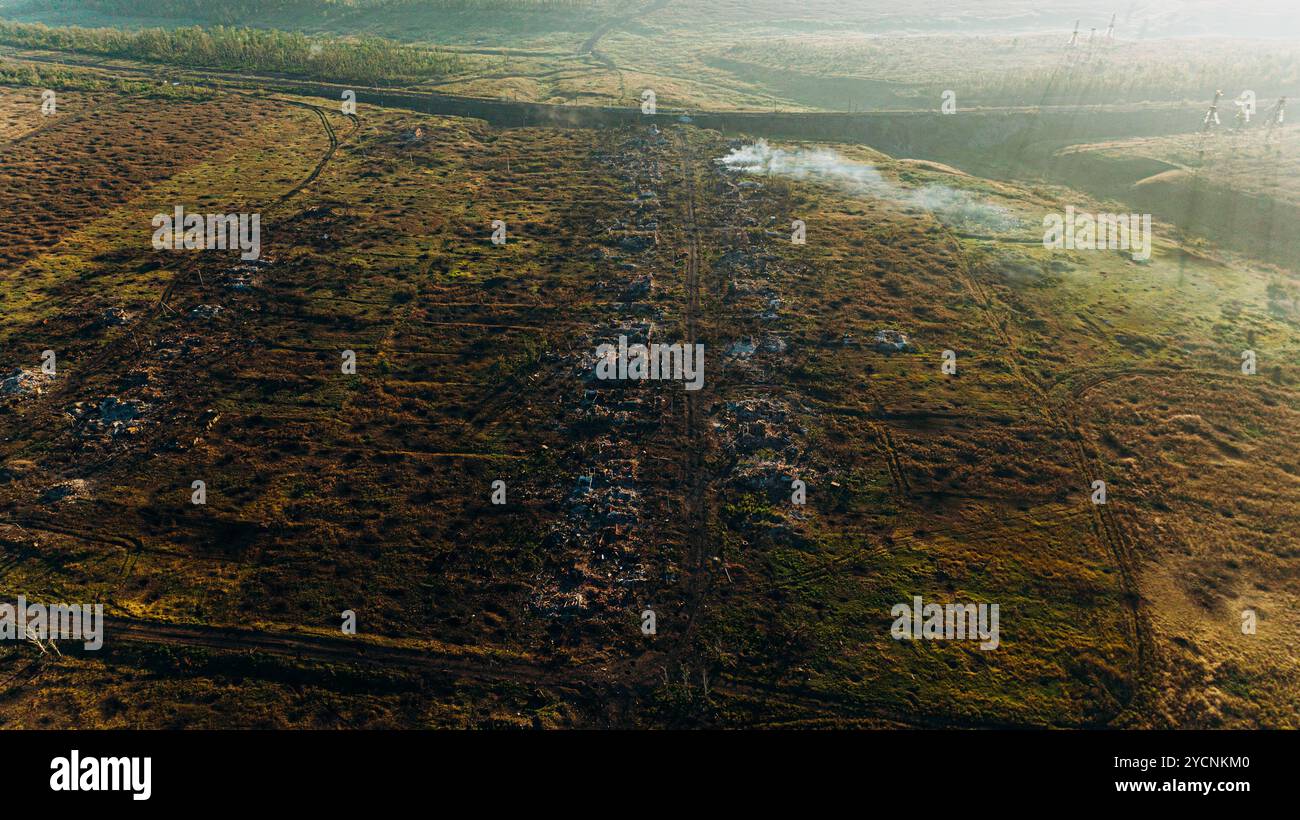 Earth after the war. Ukraine. Explosion craters and a destroyed village ...