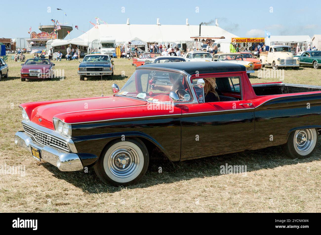 A red Ford Ranchero pickup drives around the ring at the Ackworth ...