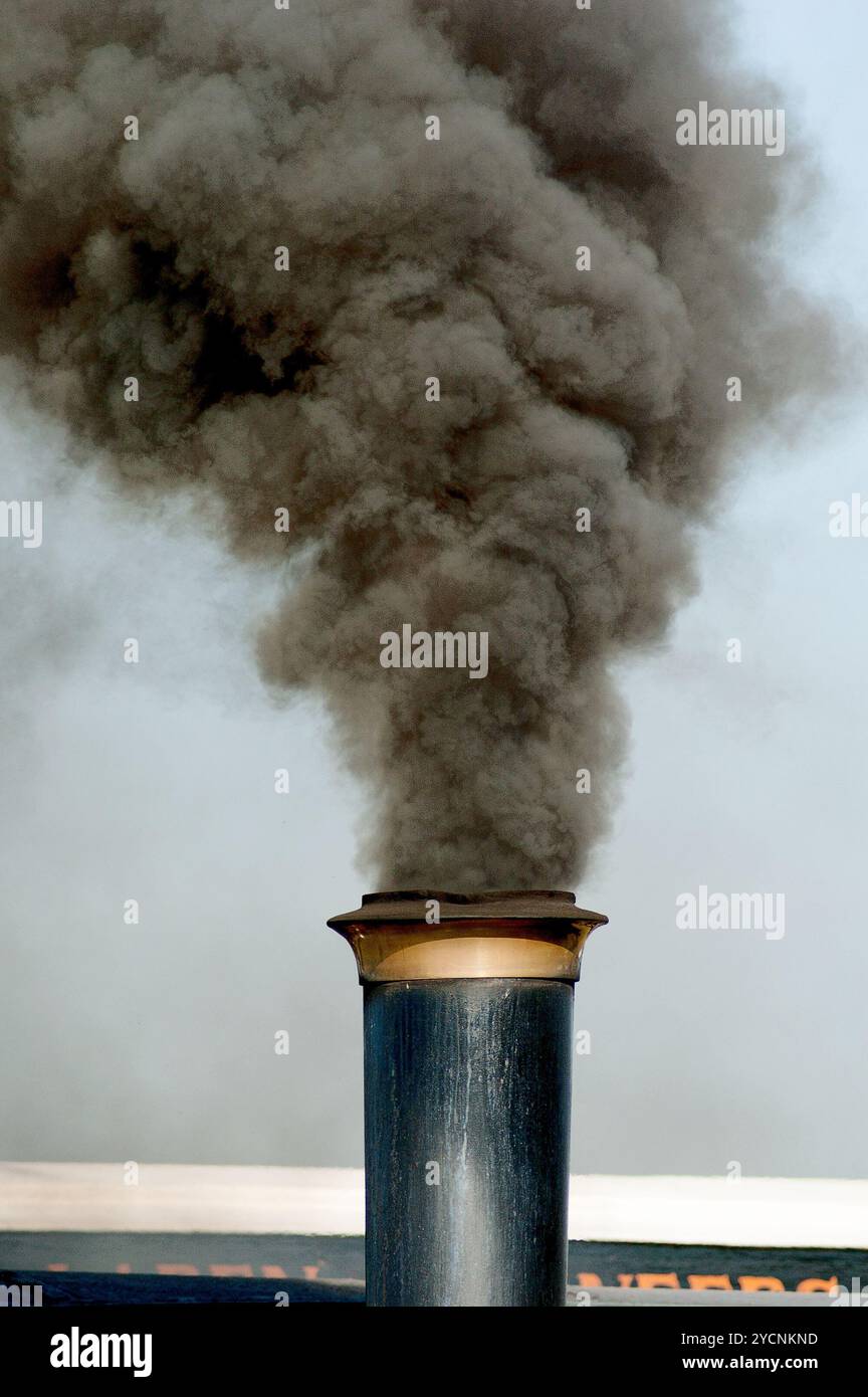 Smoke pouring from the funnel of a steam engine on display at the ...