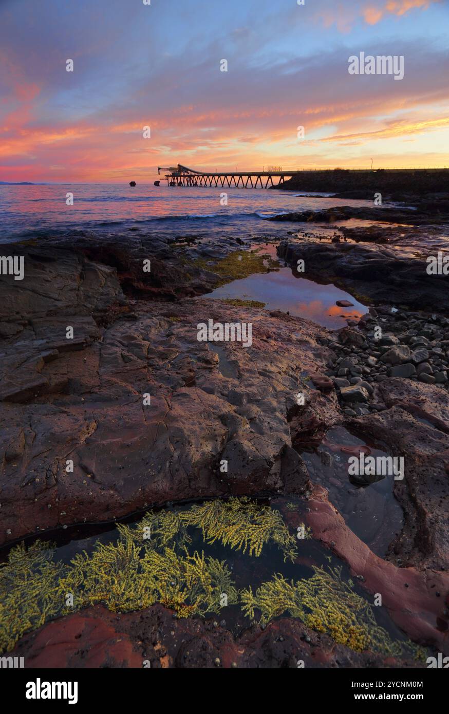 Sunrise from Bass Point with Gravel Loader pier in distance Stock Photo ...