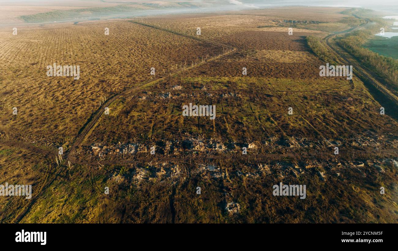 Earth after the war. Ukraine. Explosion craters and a destroyed village ...