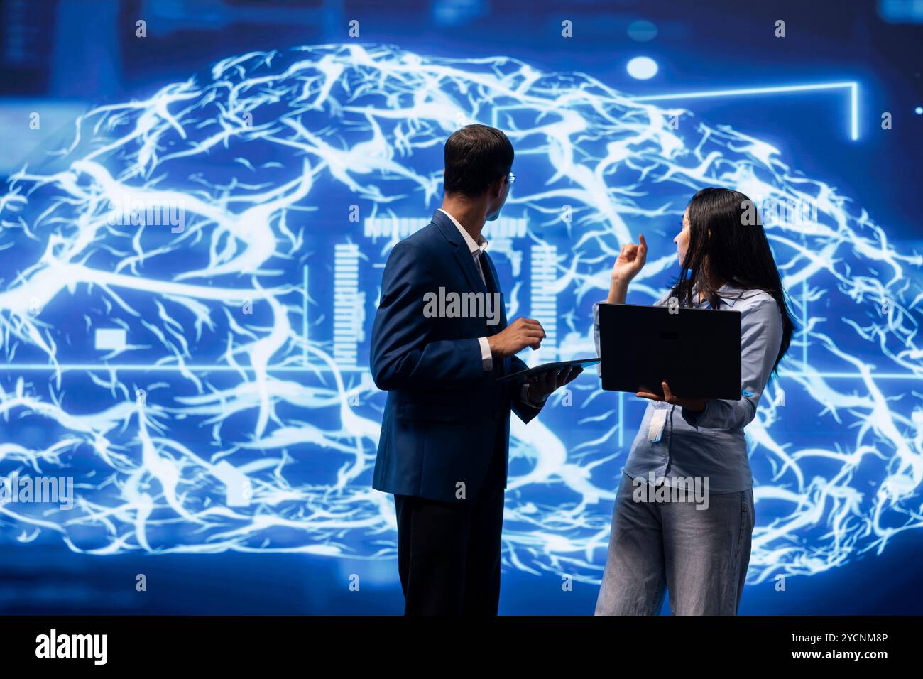 IT department coworkers solving tasks on laptop and tablet, running artificial intelligence ...