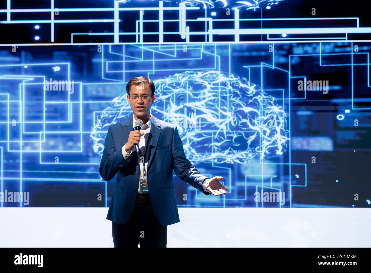 Happy presenter speaking at tech forum, explaining impact of artificial ...