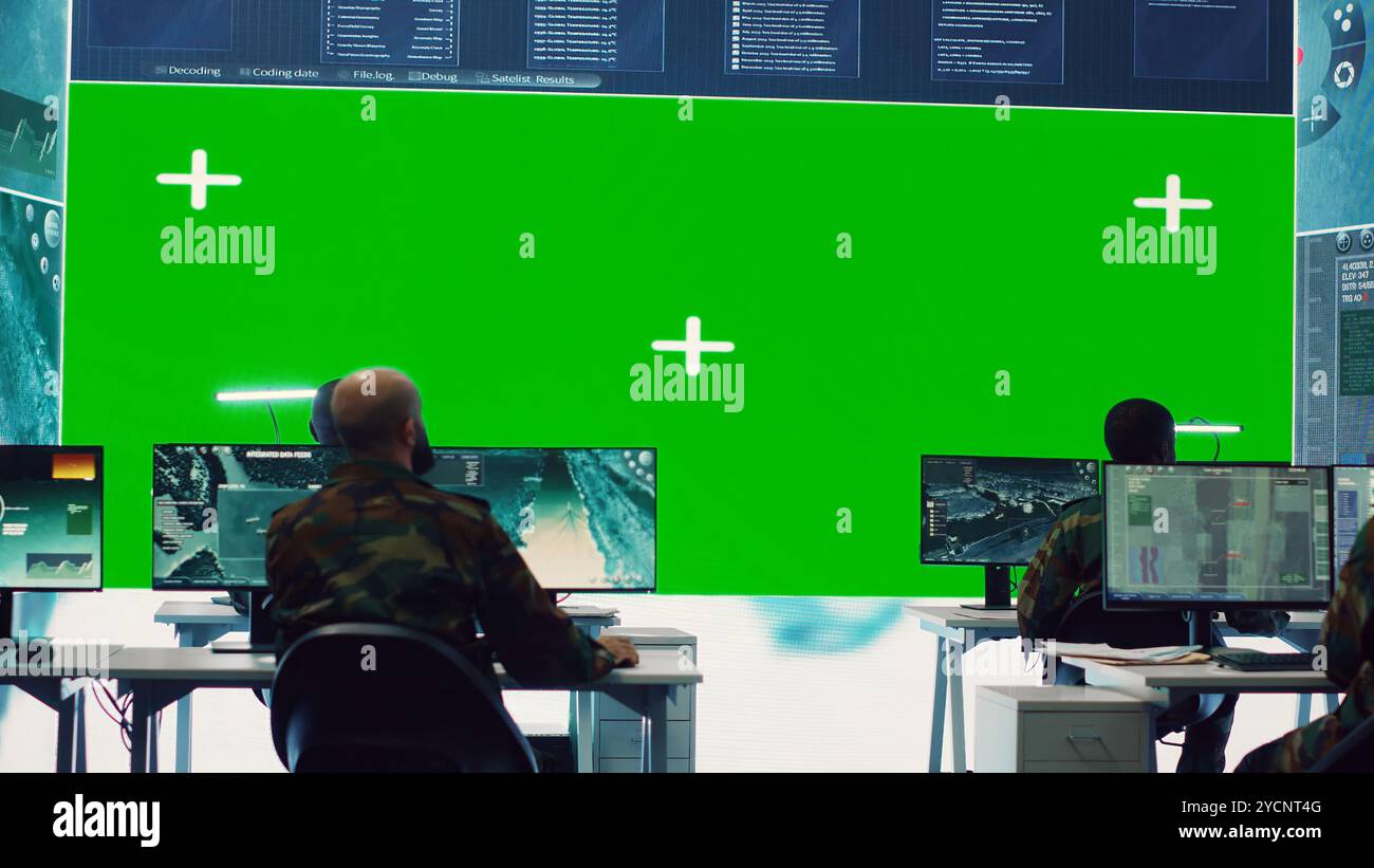 Diverse group of privates operating on a big screen isolated display ...