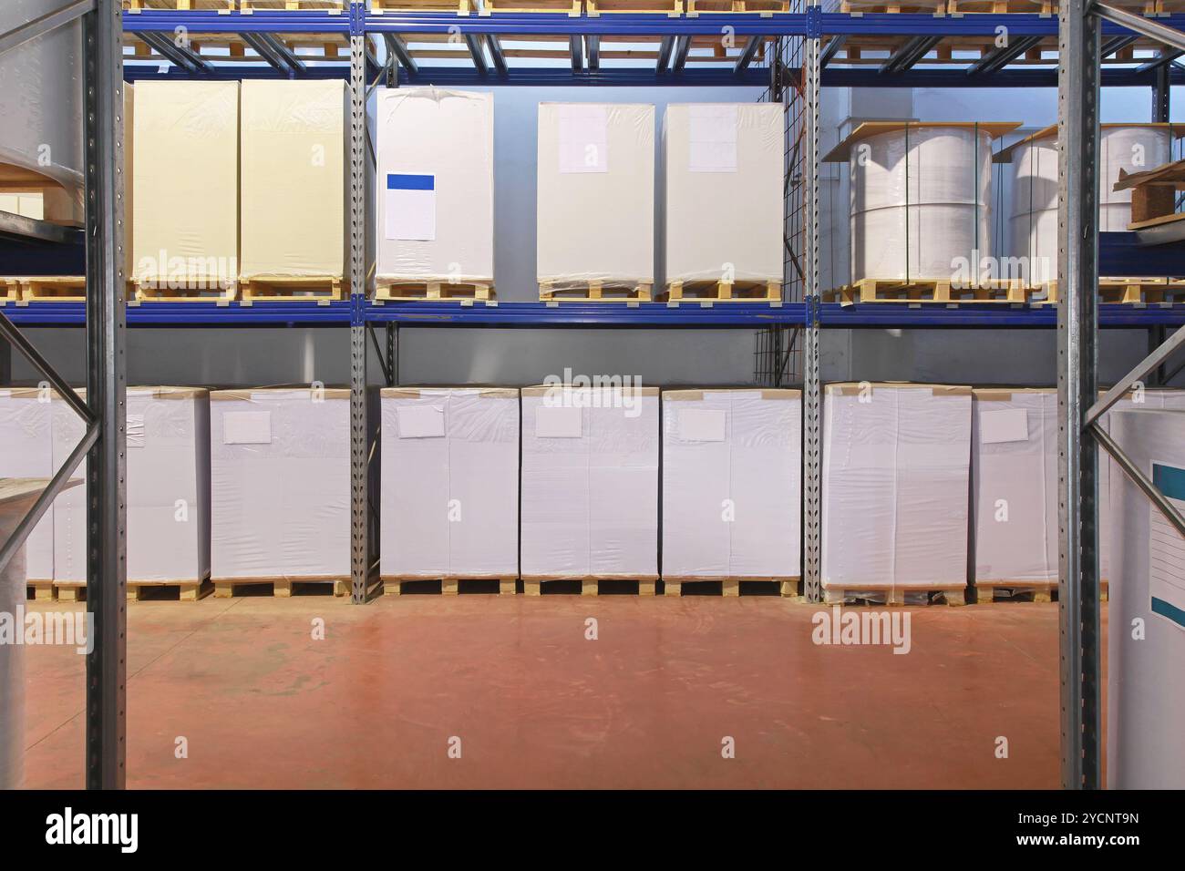 Pallets with printing paper in distrbution warehouse Stock Photo - Alamy