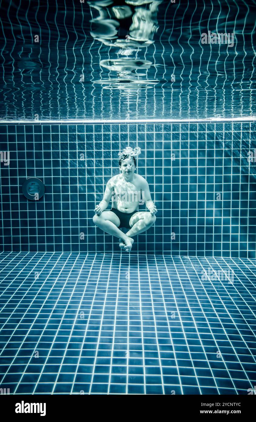 Man under water in a swimming pool to relax in the lotus position Stock ...